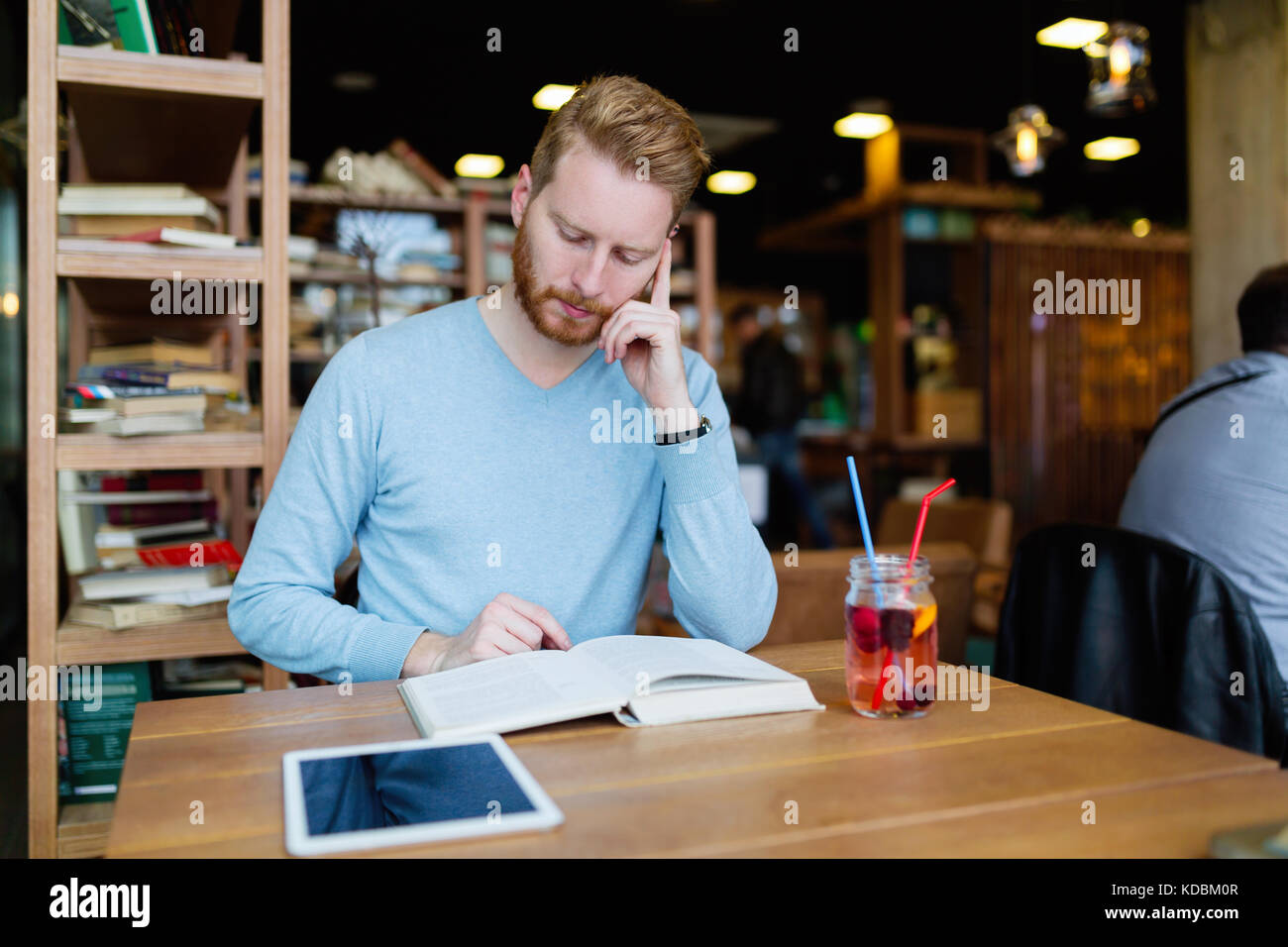 Young handsome student learning in coffee shop Stock Photo - Alamy