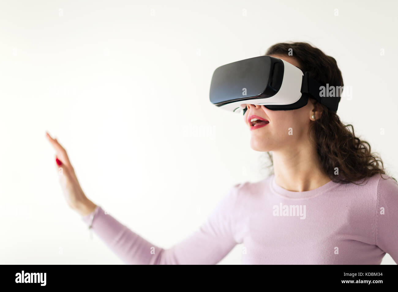 Beautiful woman virtual trying reality glasses at home Stock Photo - Alamy