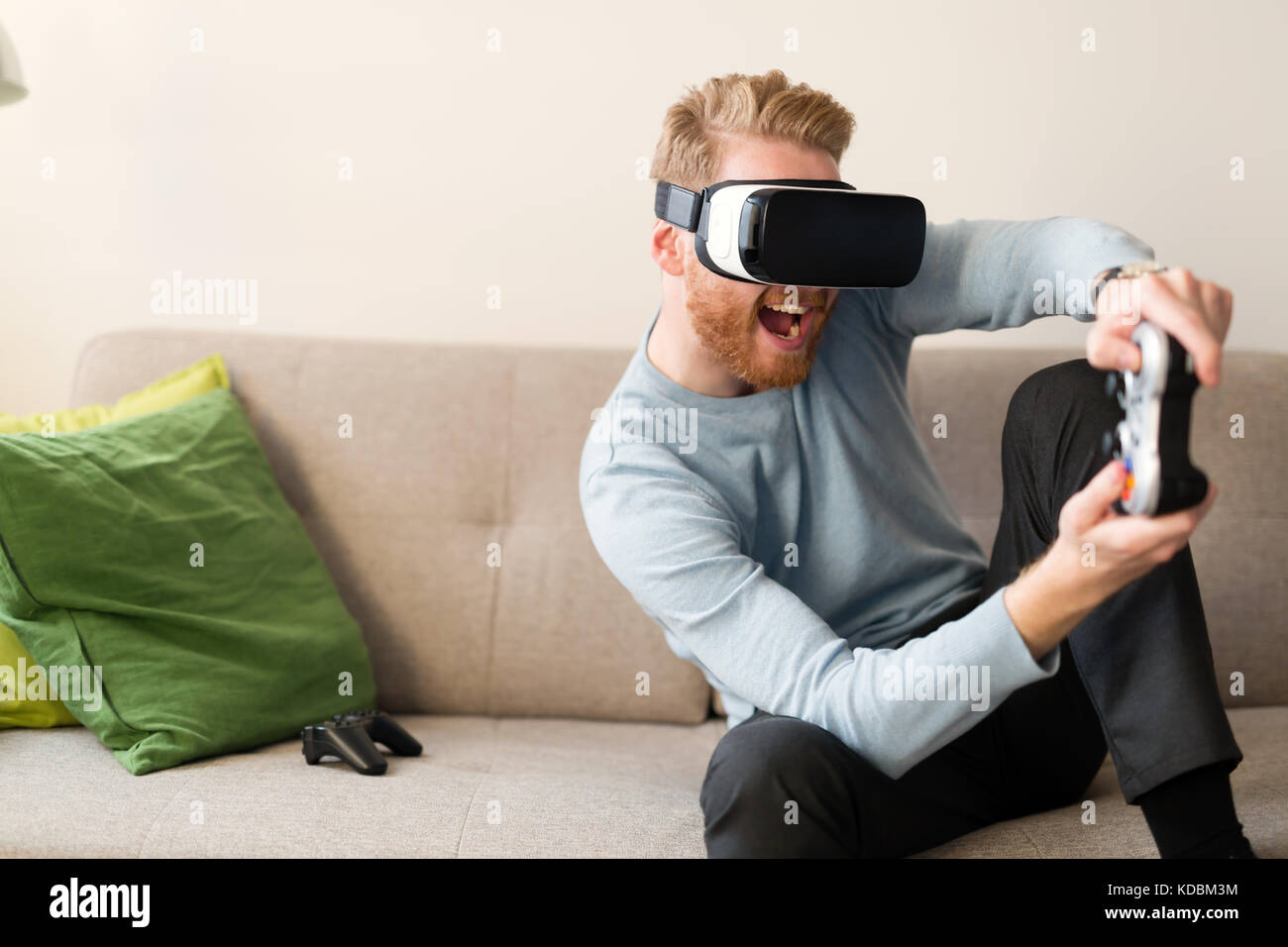 Handsome man playing video games with virtual reality headset Stock ...