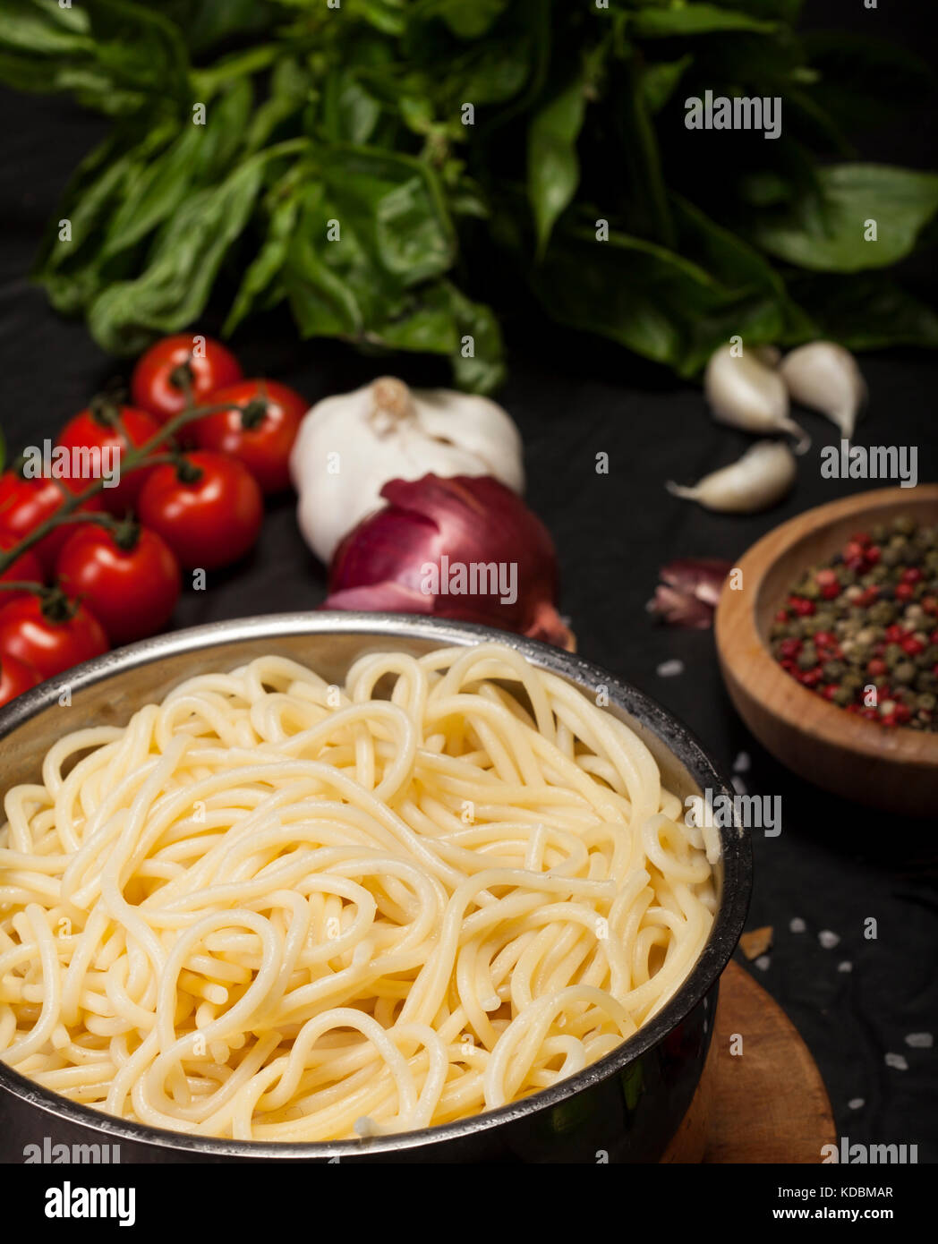 Closeup of delicious spaghetti in a pan on black background Stock Photo ...