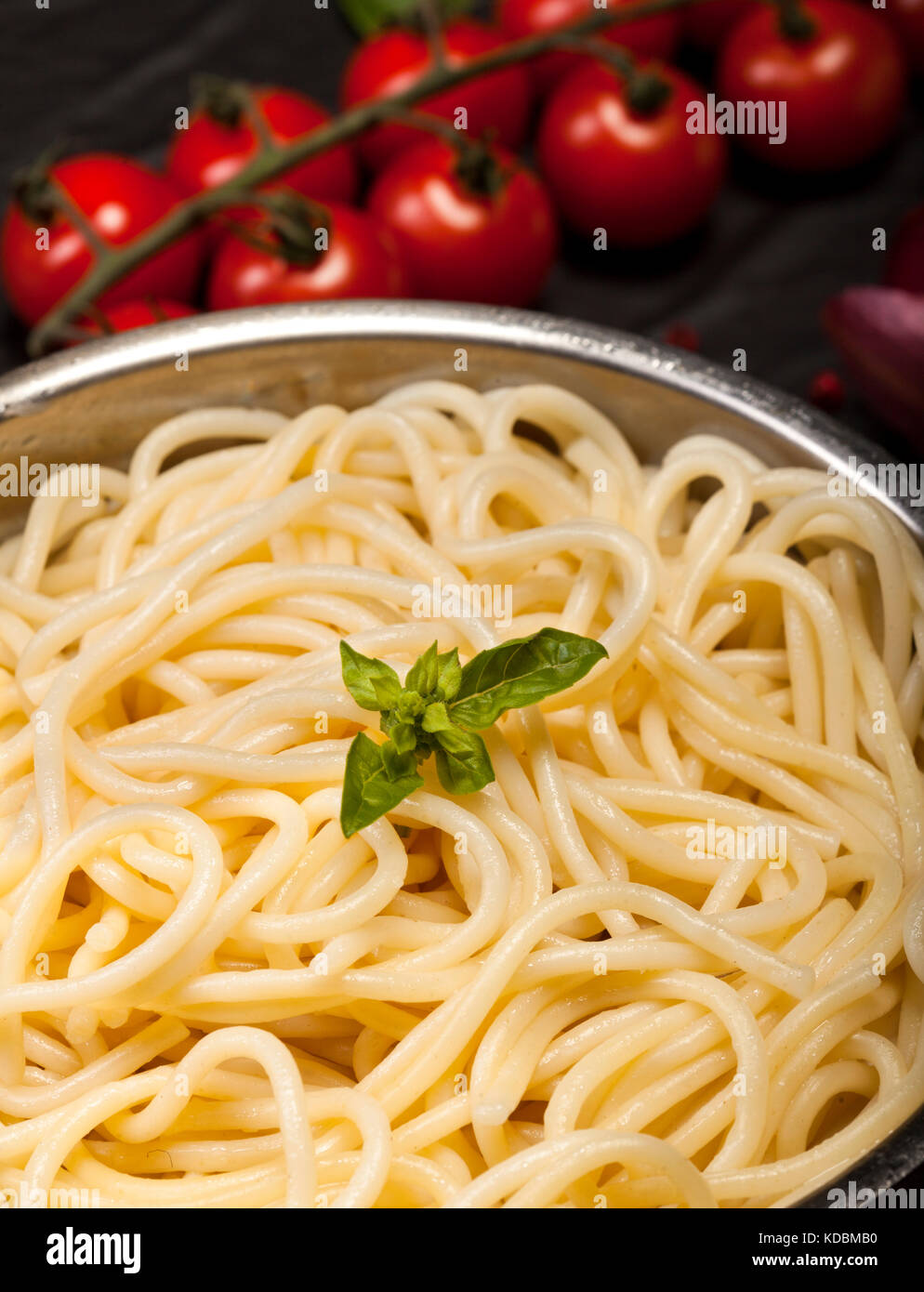 Closeup of delicious spaghetti in a pan on black background Stock Photo ...