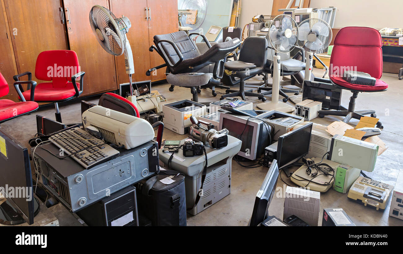 Broken office chairs and electronic waste in the store room Stock Photo ...