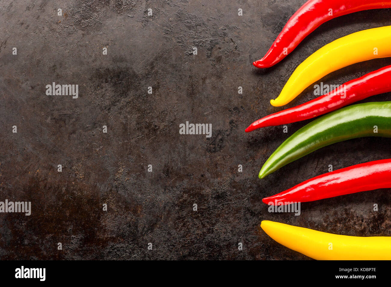 cayenne chilli peppers on rusty metal background Stock Photo - Alamy