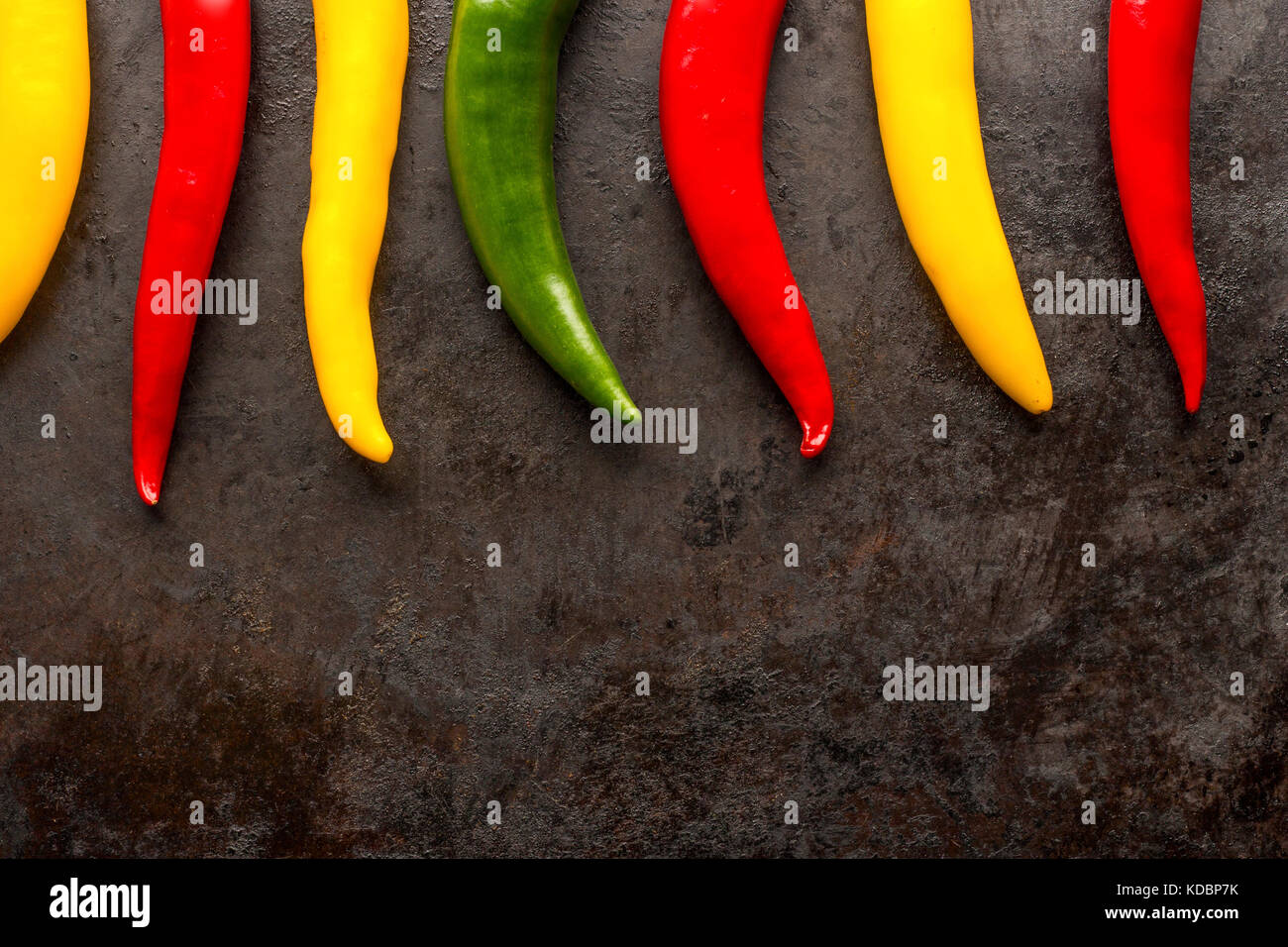 cayenne chilli peppers on rusty metal background Stock Photo - Alamy