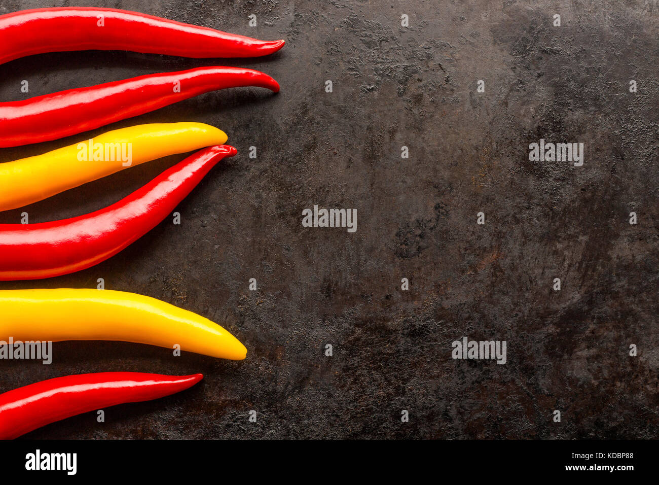 cayenne chilli peppers on rusty metal background Stock Photo - Alamy