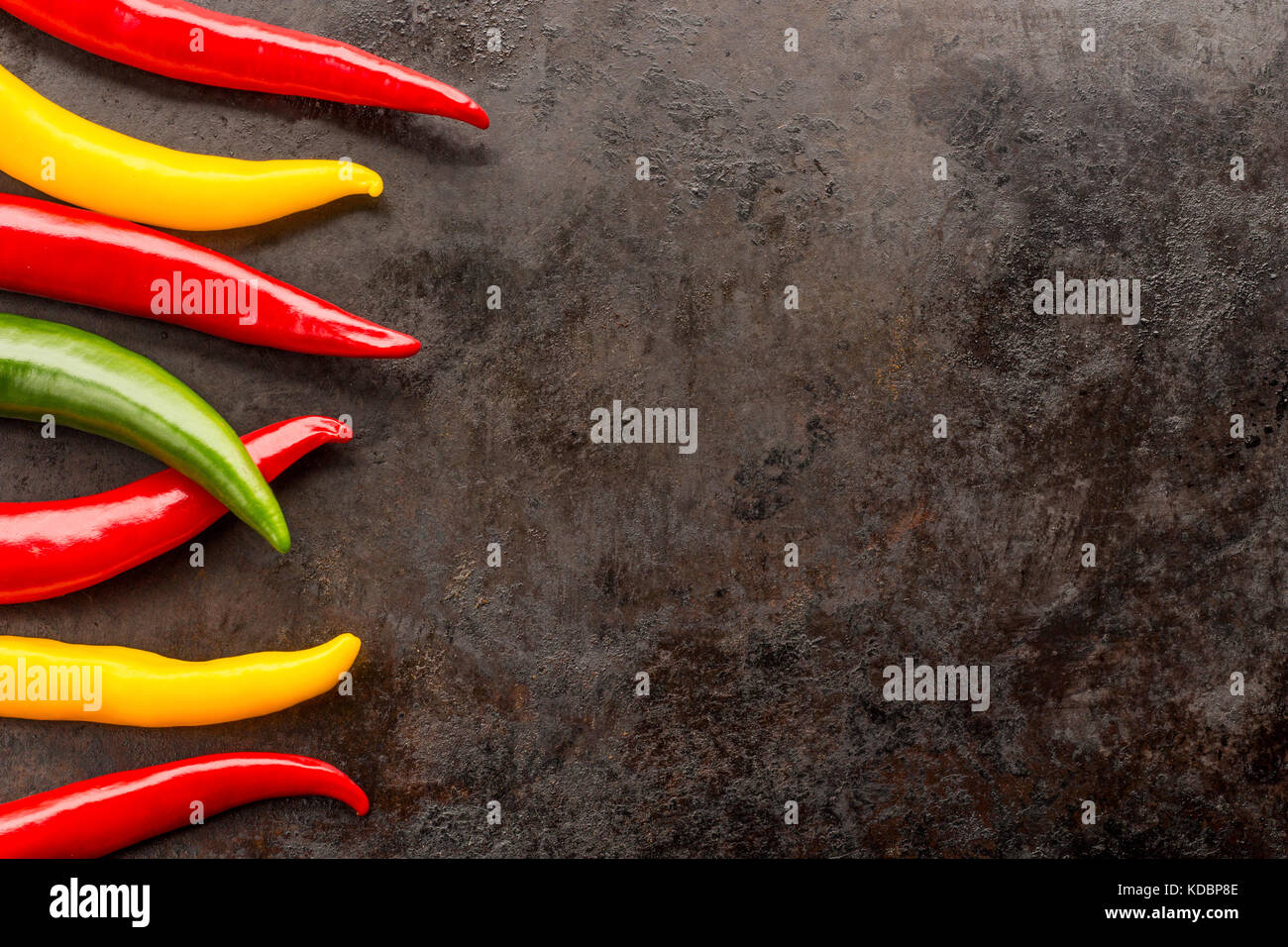 cayenne chilli peppers on rusty metal background Stock Photo - Alamy