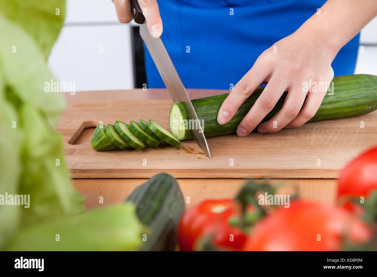 Closeup Of Young Woman In Kitchen Cutting Vegetables Stock Photo - Alamy