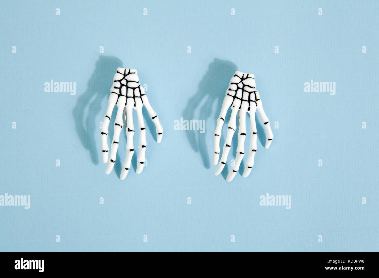 white hand skeleton on a pop vibrant blue background. Minimal color ...
