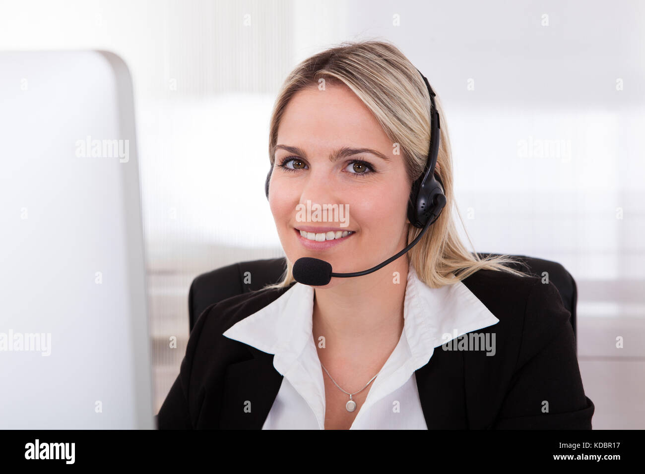 Portrait Of Happy Young woman Operator With headset Stock Photo - Alamy