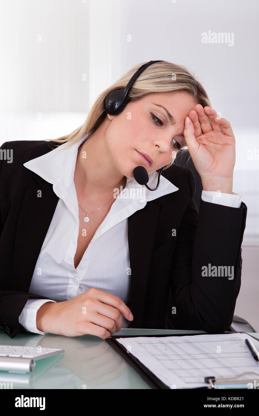 Stressed Female Call Centre Employee Sitting In Office Stock Photo - Alamy