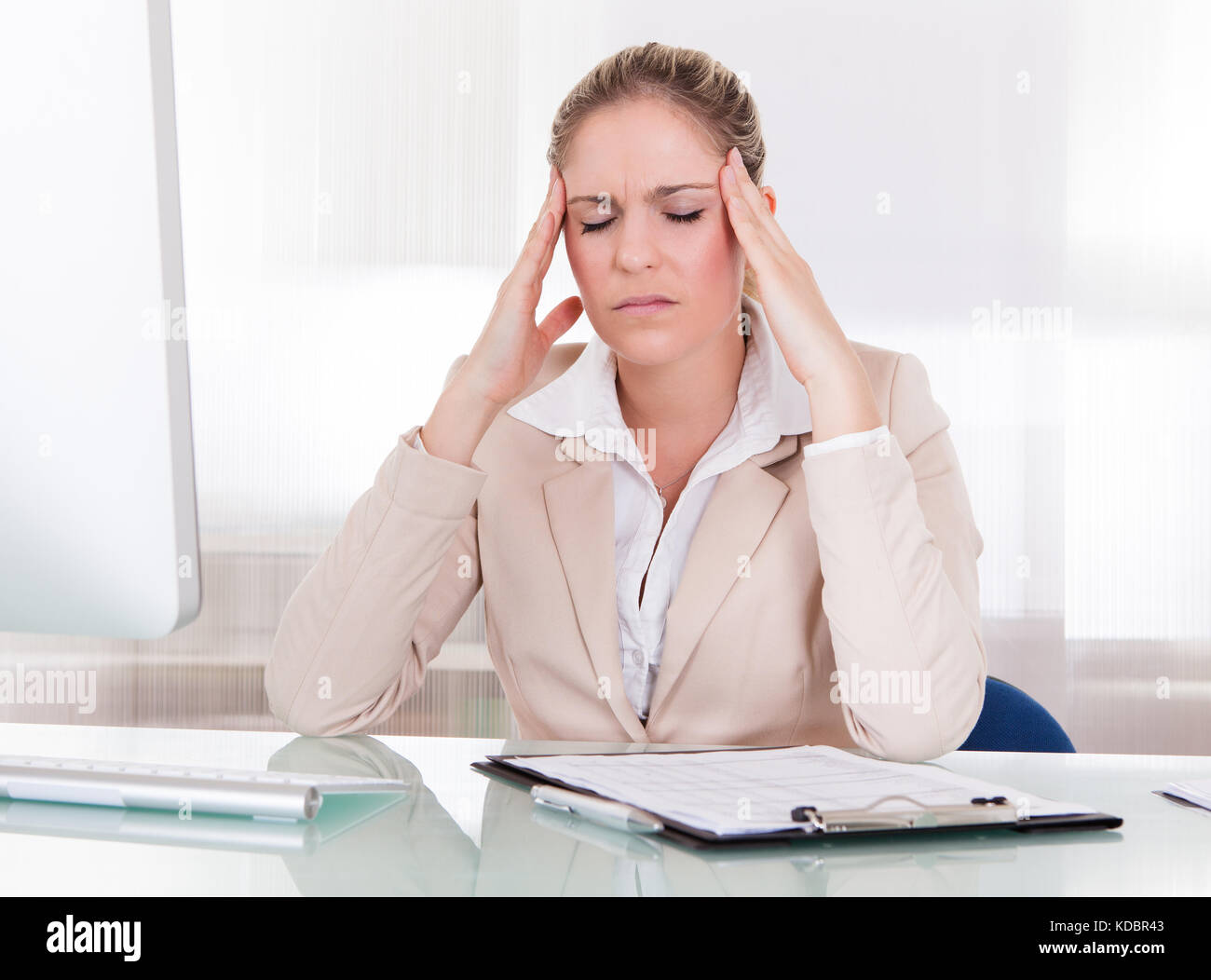 Young Businesswoman Suffering From Headache At Office Stock Photo - Alamy