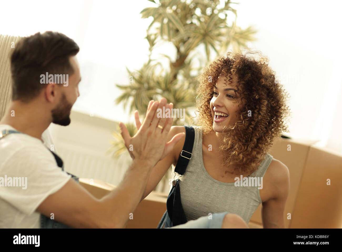 young couple giving each other five with a new home Stock Photo - Alamy