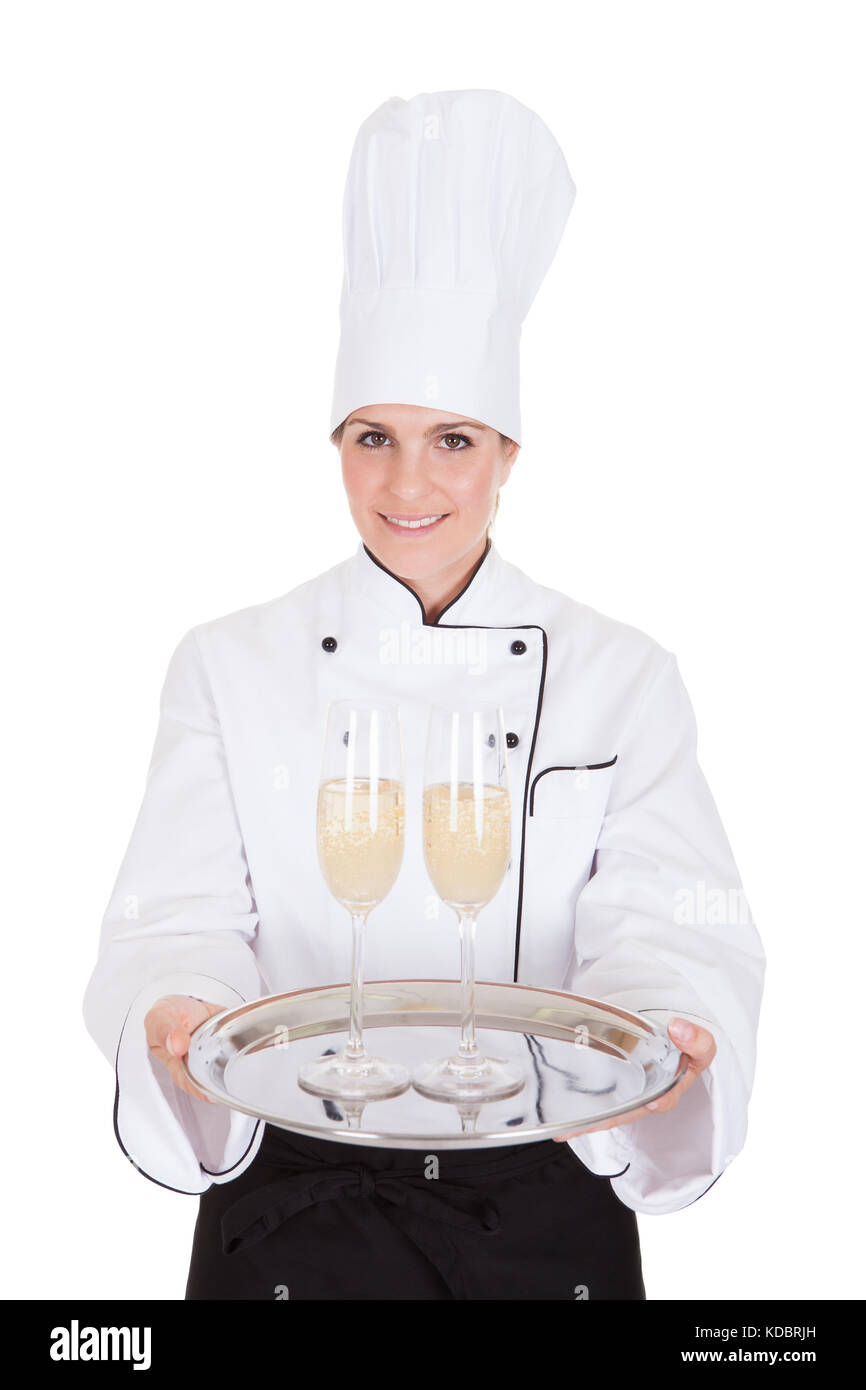 Portrait Of Female Chef Holding Champagne Over White Background Stock ...
