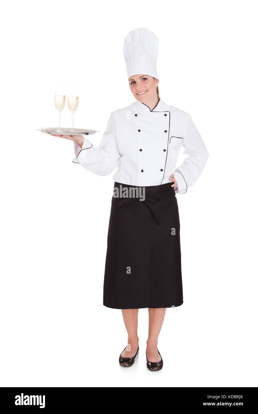 Portrait Of Female Chef Holding Champagne Over White Background Stock ...