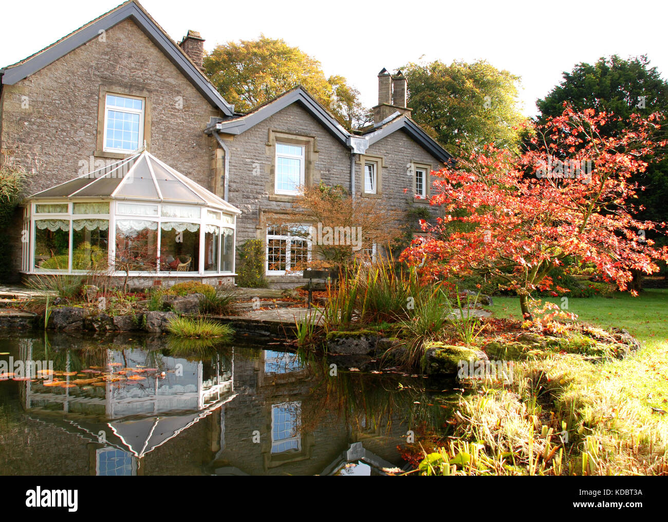 Large pond in front of triple gable house Stock Photo - Alamy