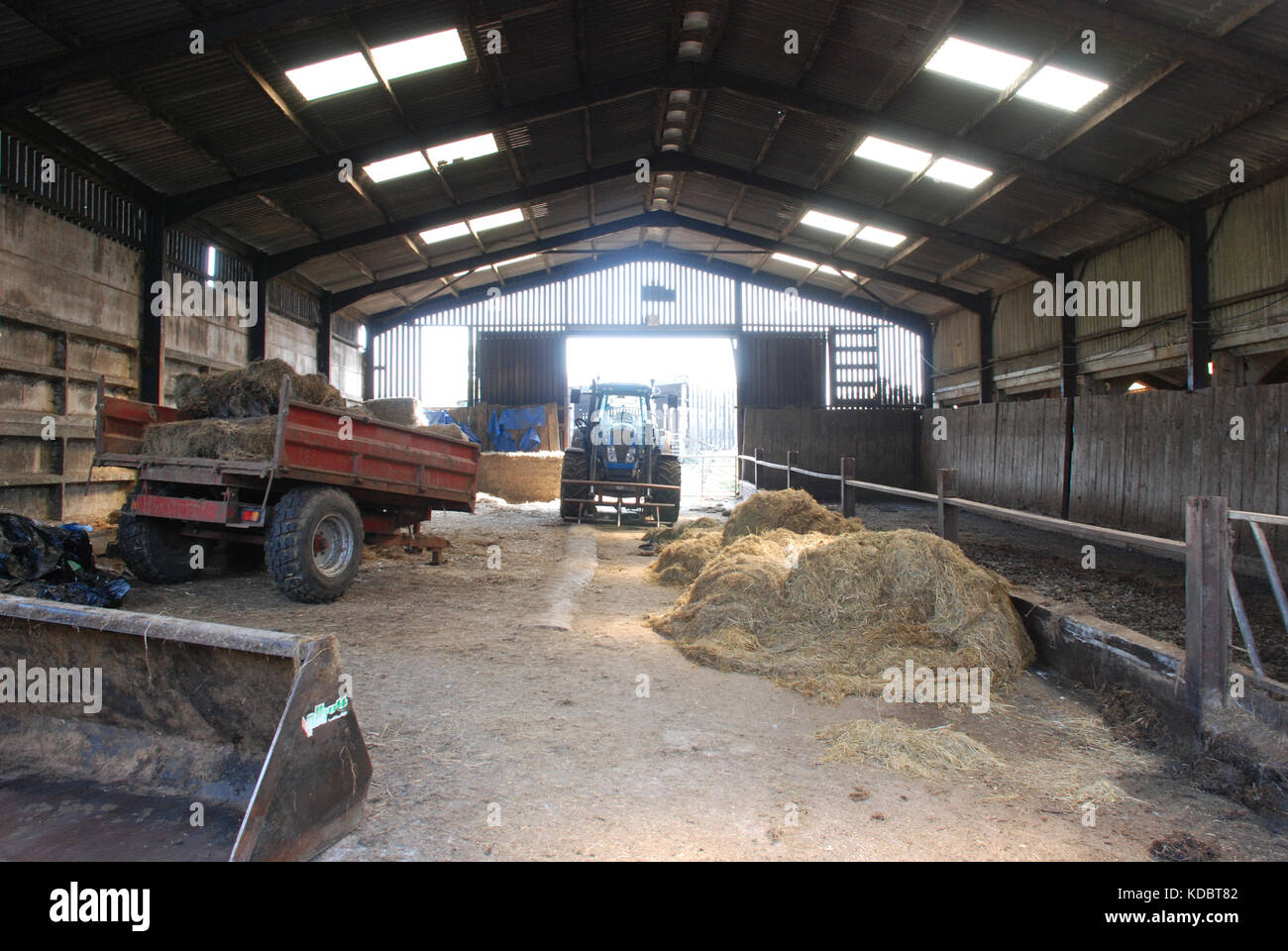 Open barn with hay and farm machinery Stock Photo - Alamy