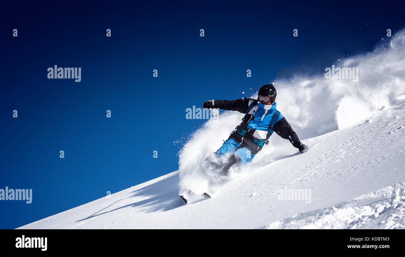 Extreme skier skiing powder snow Stock Photo - Alamy