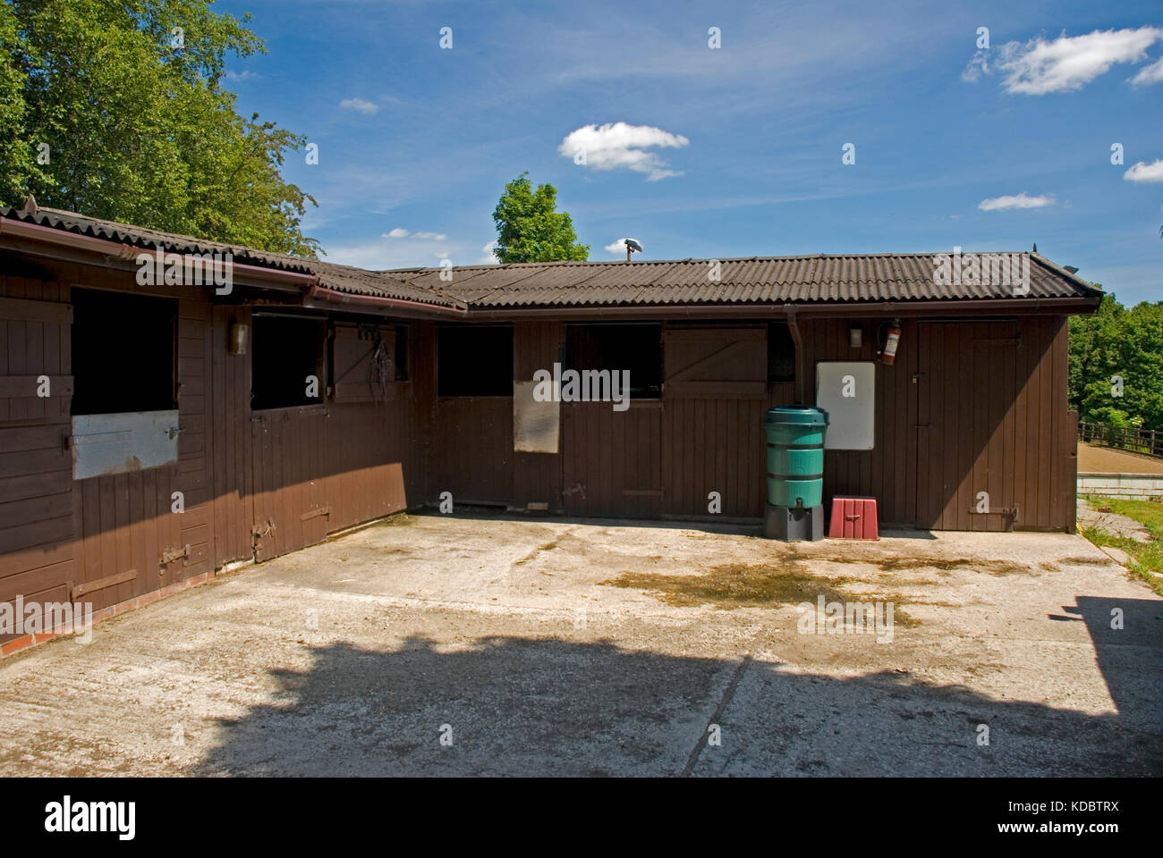 Horse stable block with sunshine and blue sky Stock Photo - Alamy