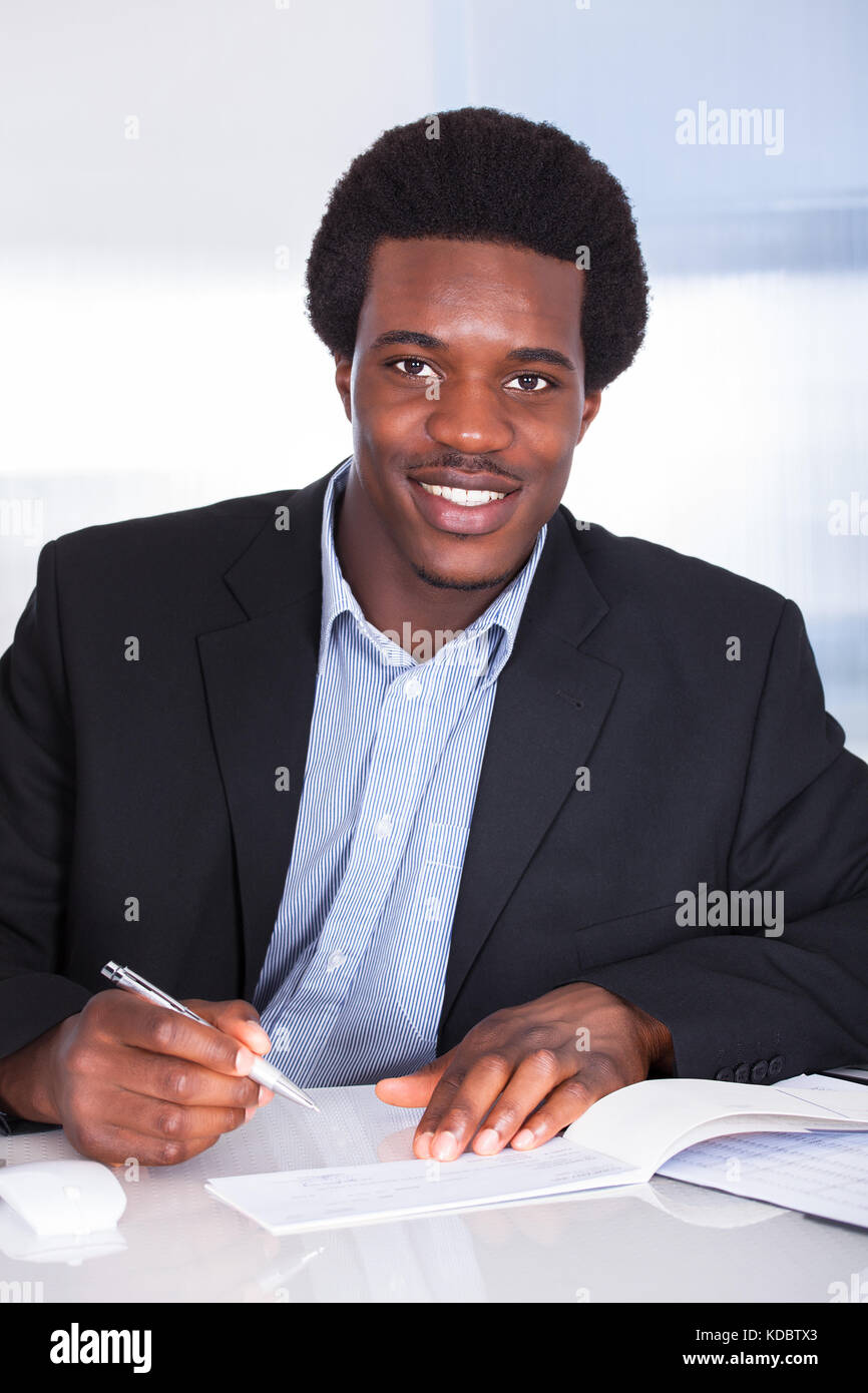 Close-up Of Human Hand Writing On Cheque Stock Photo - Alamy