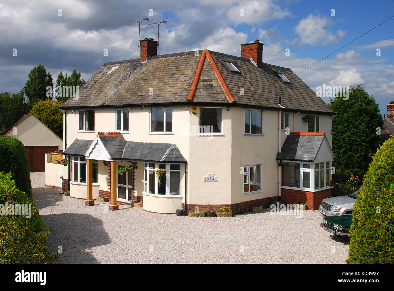 Large detached family home with shingle driveway Stock Photo - Alamy