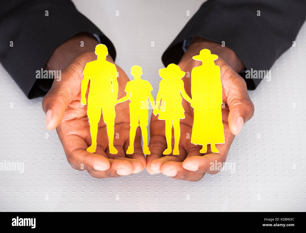 Close-up Of Male Hand Holding Family Cutout Shape Stock Photo - Alamy