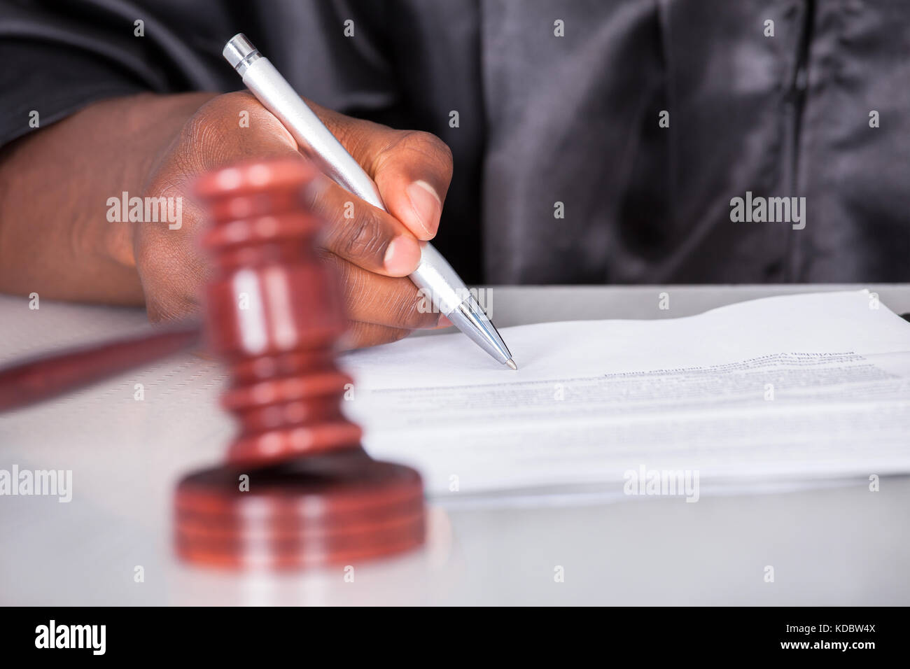 Close-up Of A Male Judge Writing On Paper In Courtroom Stock Photo - Alamy