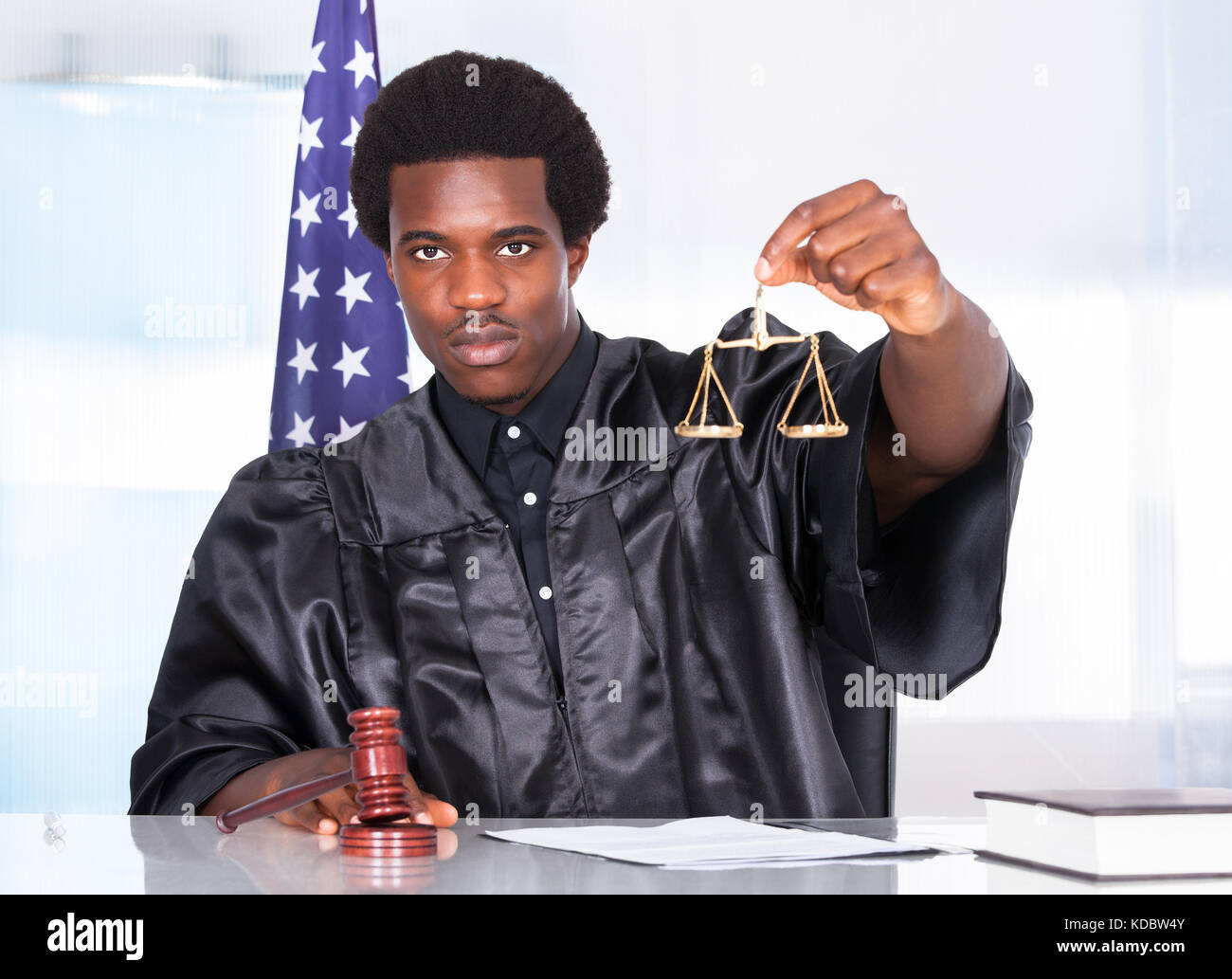 Portrait Of A African Judge Holding Gavel And Scale In Courtroom Stock ...