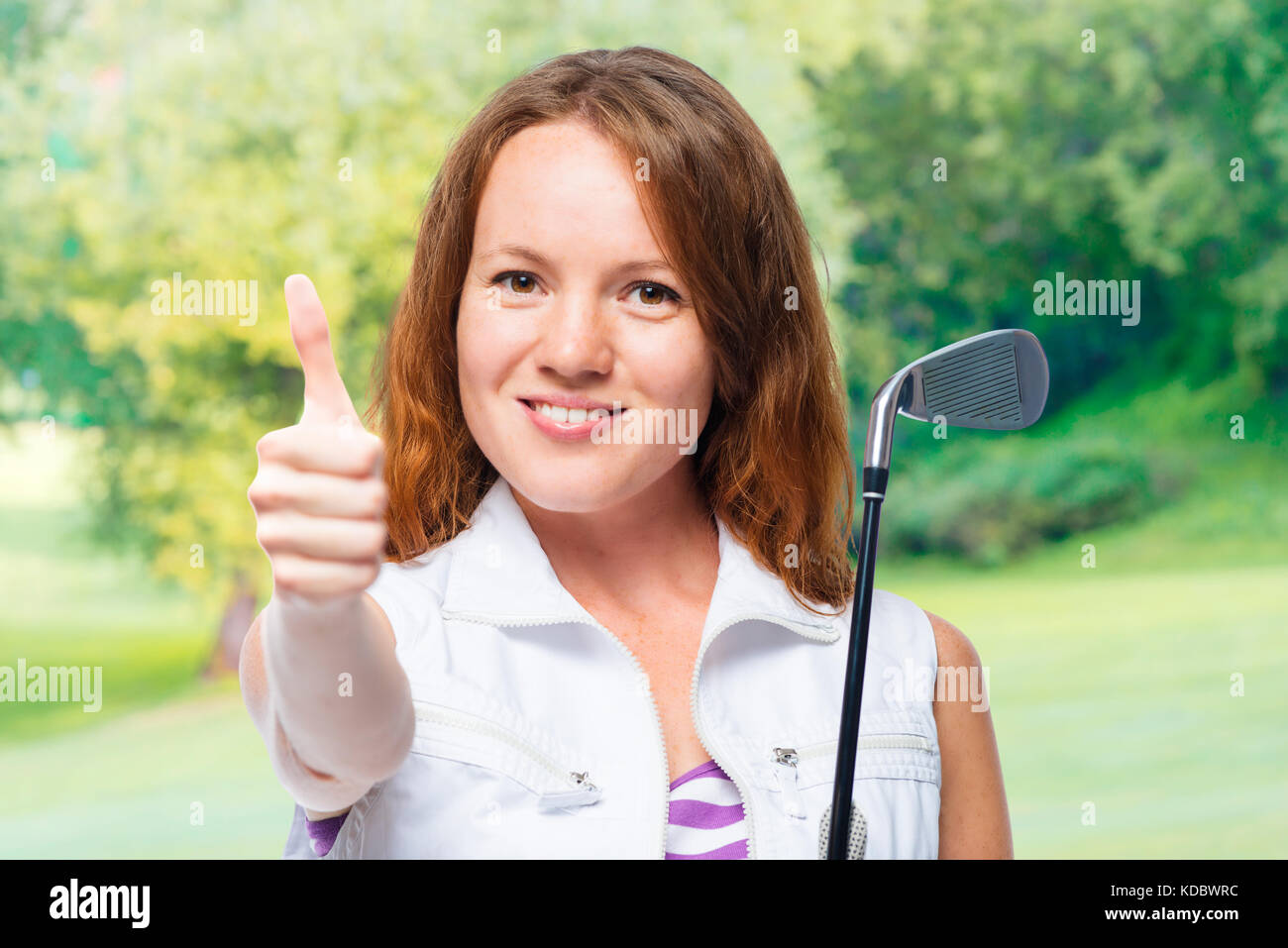 Smiling golfer showing thumbs up on a background of golf courses Stock ...