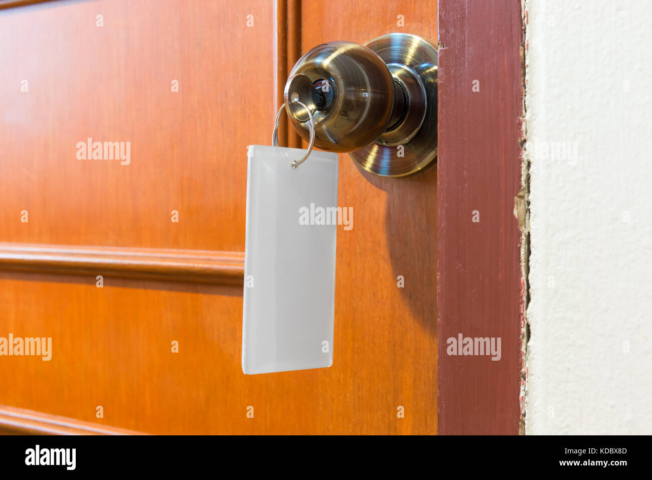 key with a tag in the lock close up Stock Photo - Alamy