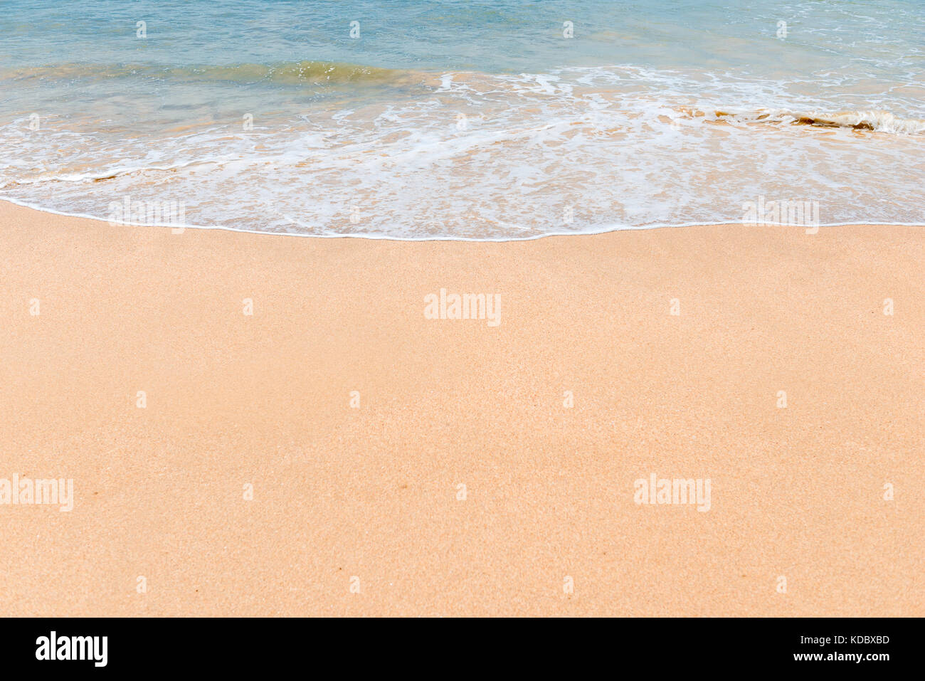 fine soft sand on the beach and wave close up Stock Photo - Alamy