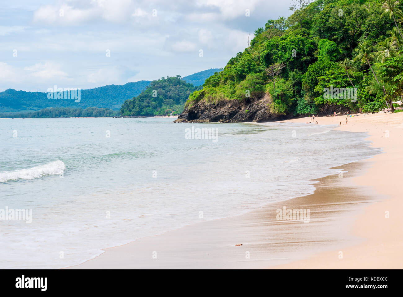 a beach with long waves of sea, rolling on the shore, beautiful rocks ...