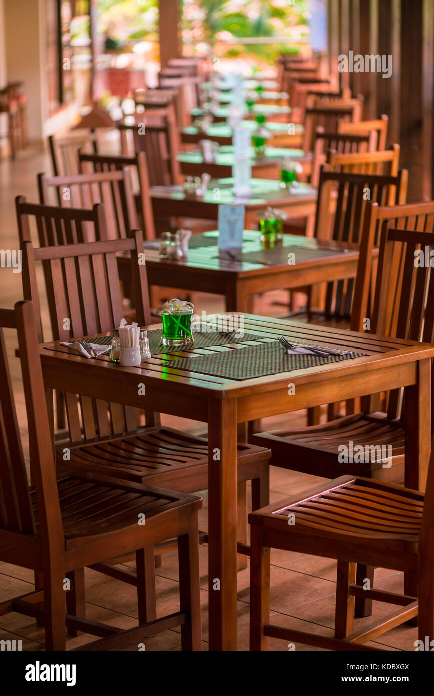 tables stand in a row on an open veranda in the tropics Stock Photo - Alamy