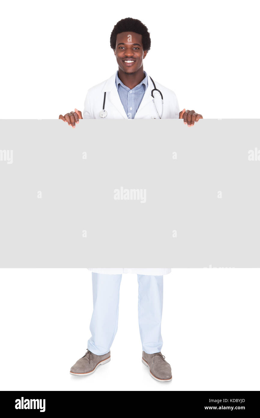 Portrait Of A Happy African Male Doctor Standing Behind Placard On ...
