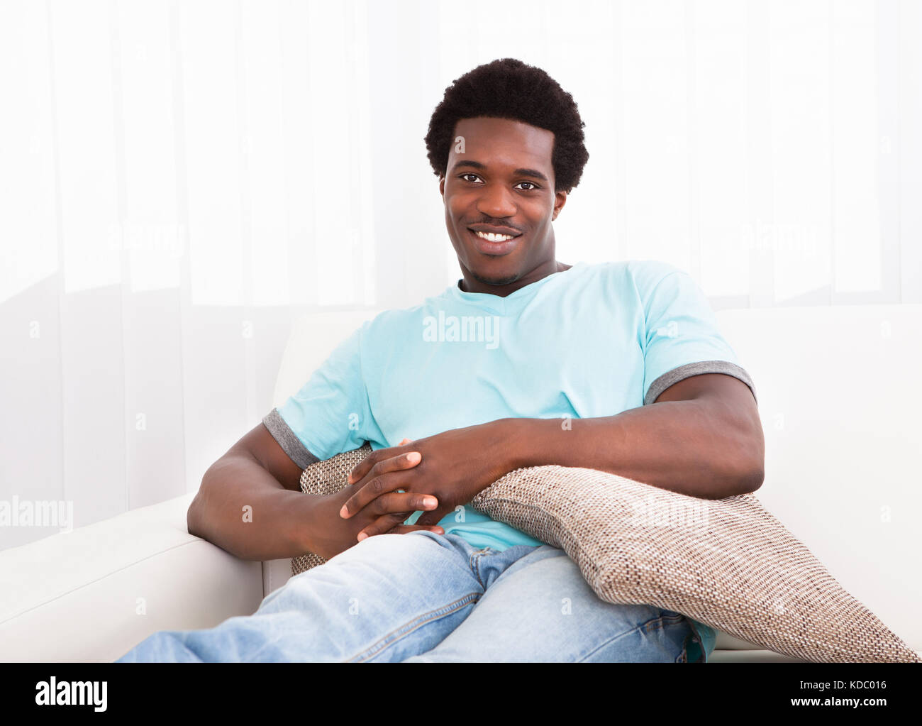 Black guy sitting hi-res stock photography and images - Alamy