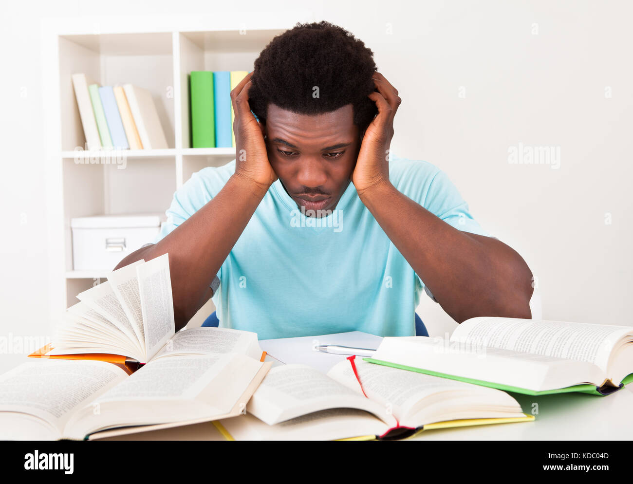 Worried Young African Man Studying At Home With A Lot Of Books Stock ... Worried Young African Man Studying At Home With A Lot Of Books Stock ...