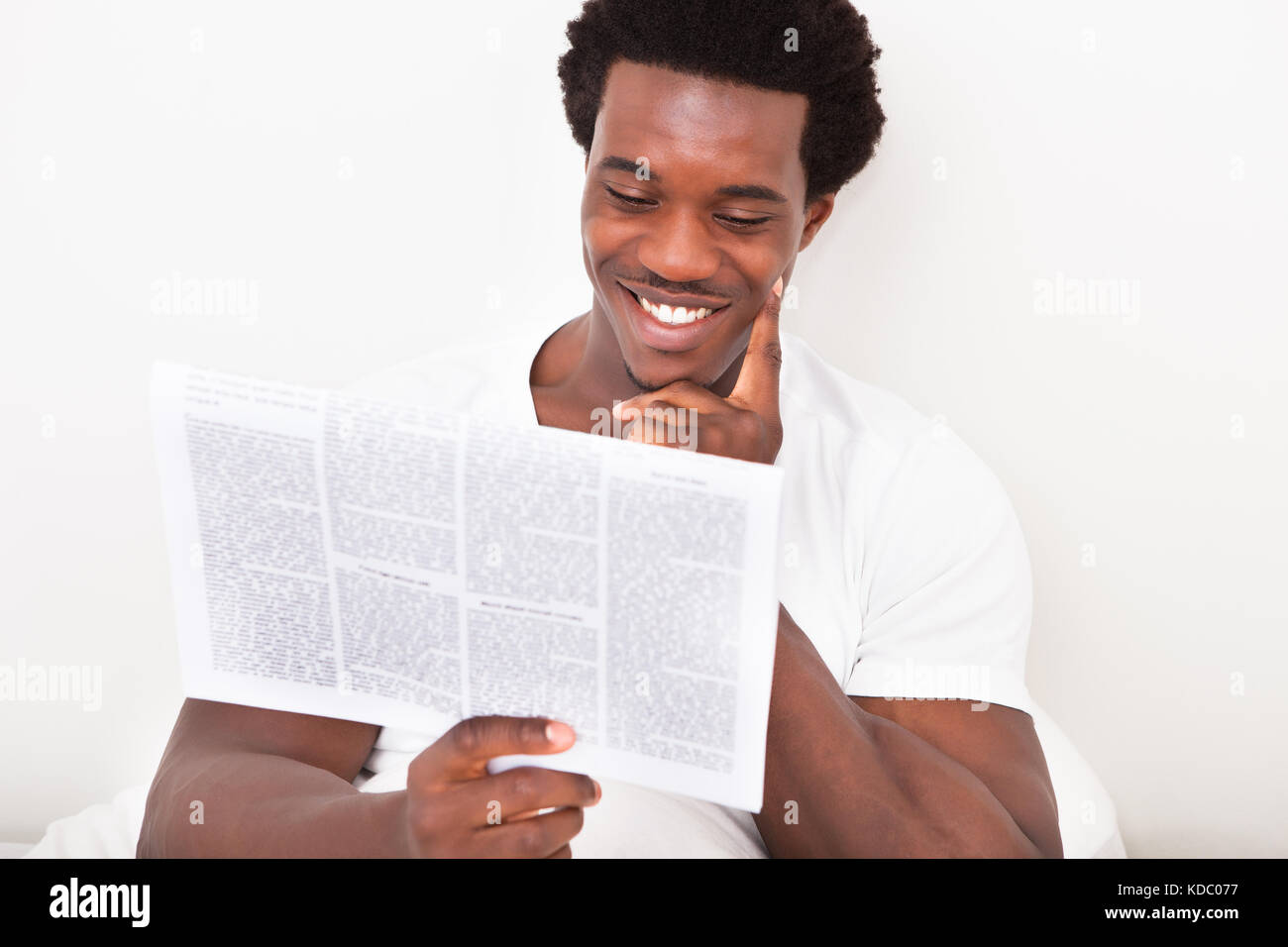 African man reading newspaper hi-res stock photography and images - Alamy