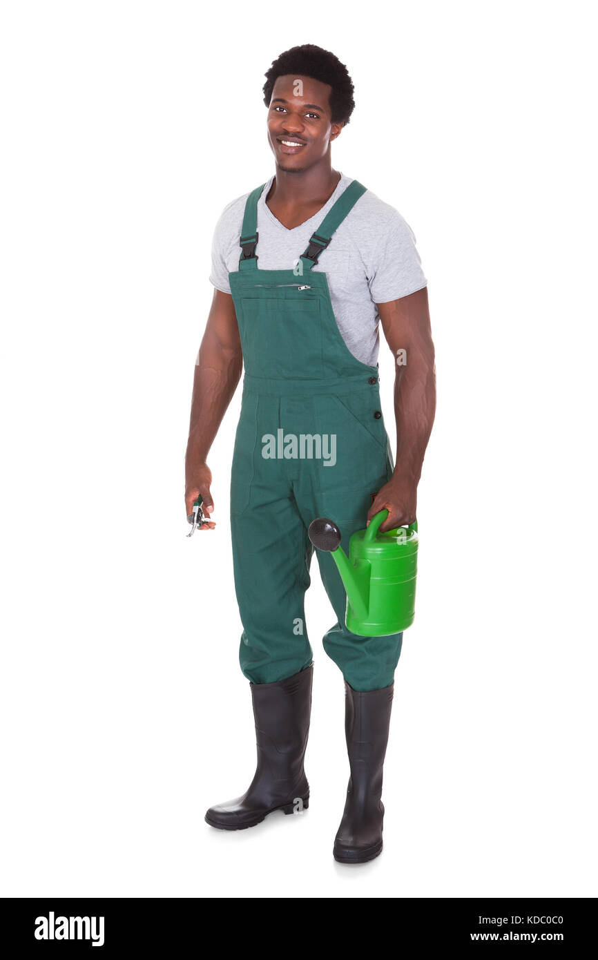 Happy Male Gardener Holding Watering Can And Pliers Over White ...