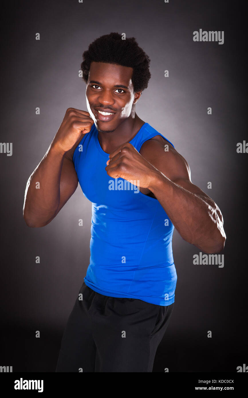 Portrait Of Young Happy African Man Over Black Background Stock Photo ...