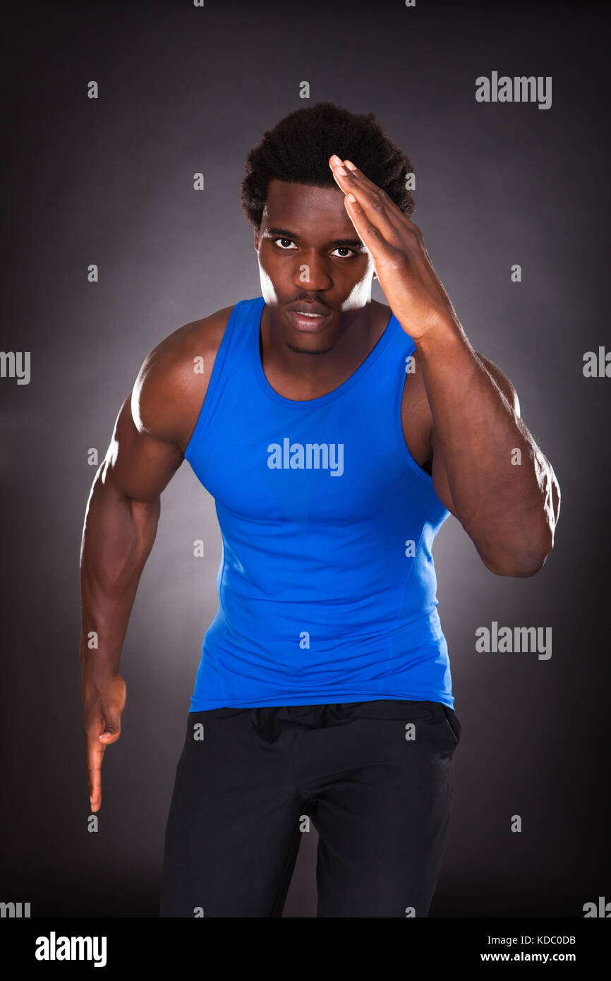 Portrait Of Young African Man Running Over Black Background Stock Photo ...