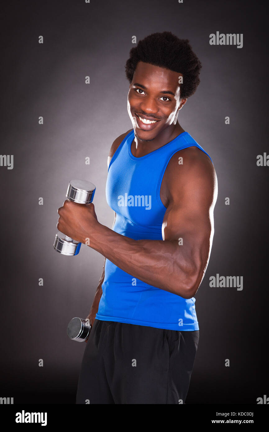 Young African Man Working Out With Dumbbells Stock Photo - Alamy