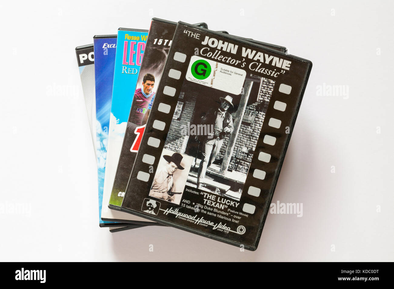 pile of DVDs with The John Wayne Collector's Classic DVD on top set on ...