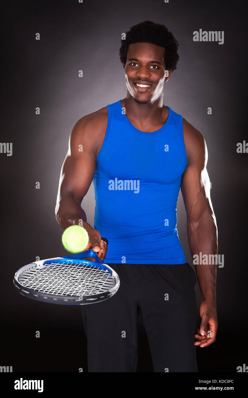 Young African Man Playing Tennis With Tennis Racket Stock Photo - Alamy