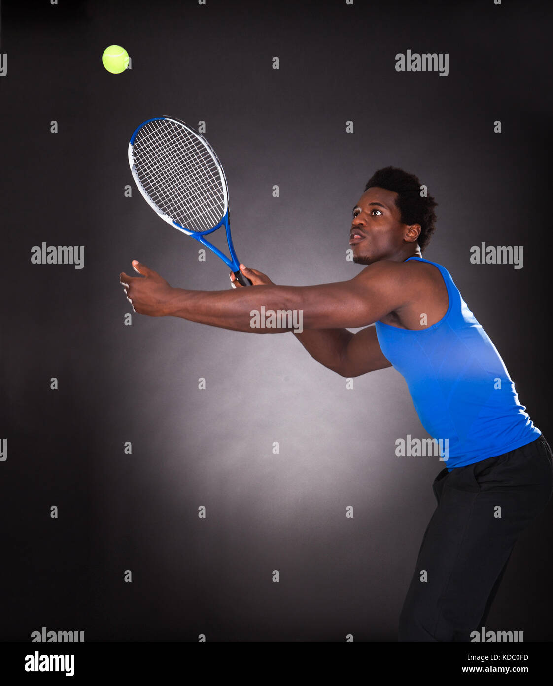 Young African Man Playing Tennis With Tennis Racket Stock Photo - Alamy