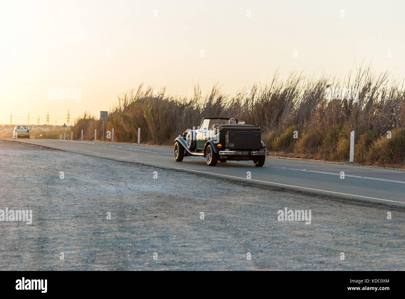 Elegant older man driving classic car at sunset - Beauford Tourer ...