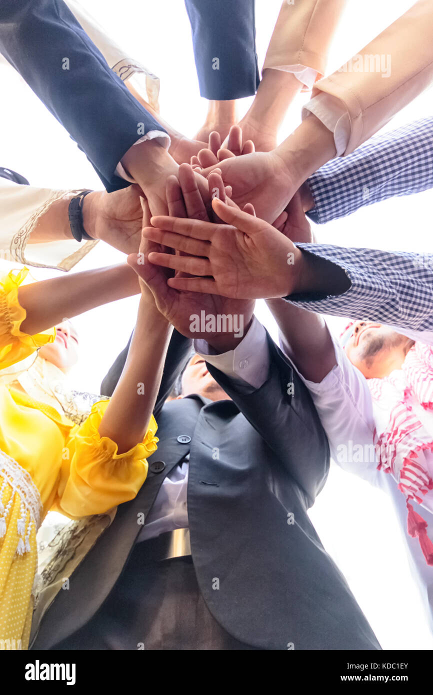 International business team showing unity with their hands together Stock Photo - Alamy