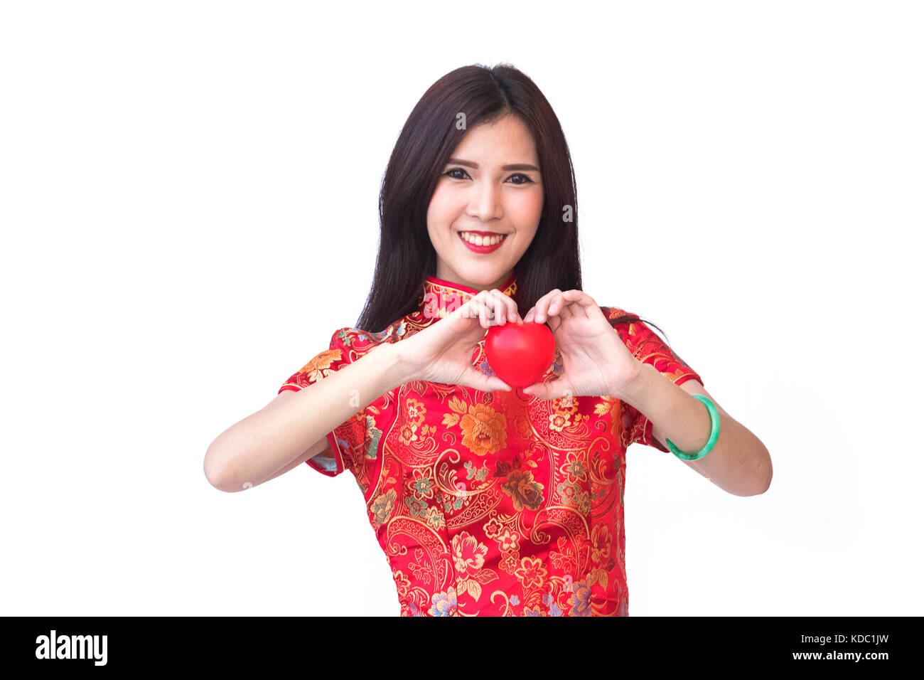 Smiling Chinese woman dress traditional cheongsam give a red heart ...