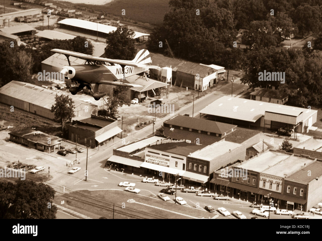 A Pitts Special biplane flies over the Main Street of Plains, Georgia ...