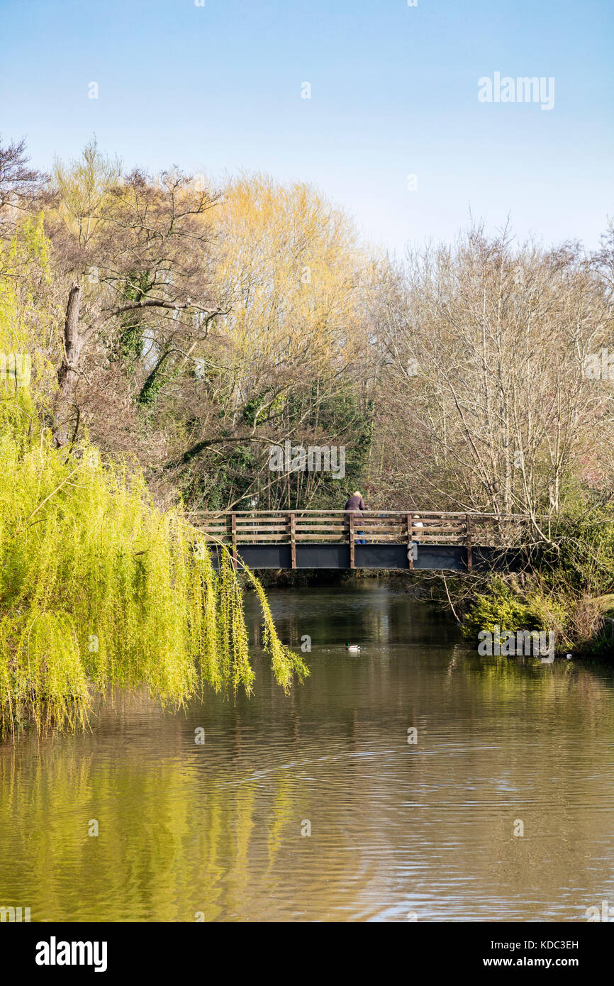 A mother and child look over a footbridge on the River Medway at ...