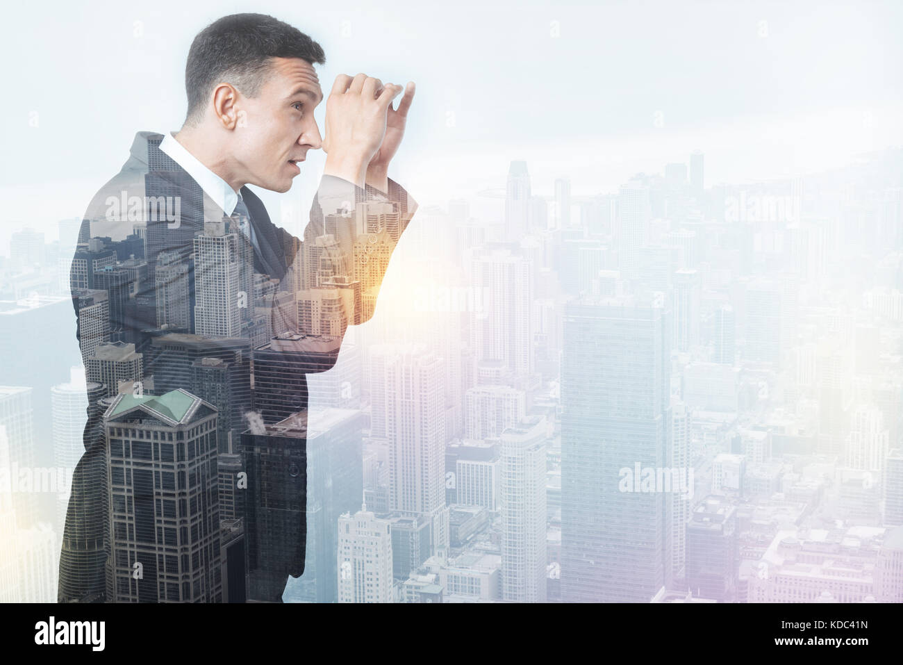Curious man looking in imaginary binocular Stock Photo - Alamy