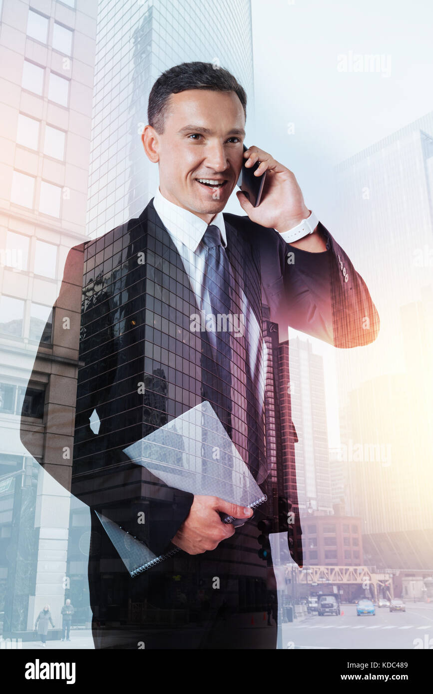 Successful manager talking on the phone and smiling Stock Photo - Alamy